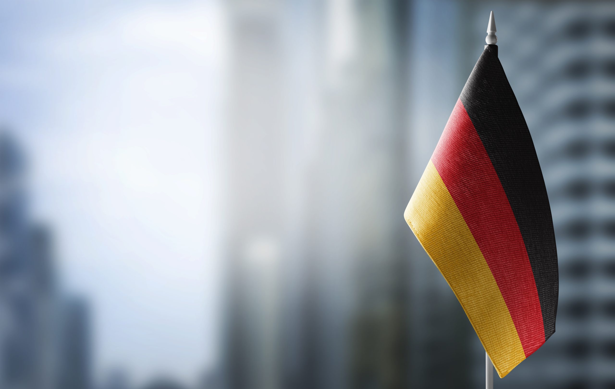 small-flag-germany-blurred-city-scaled.jpg